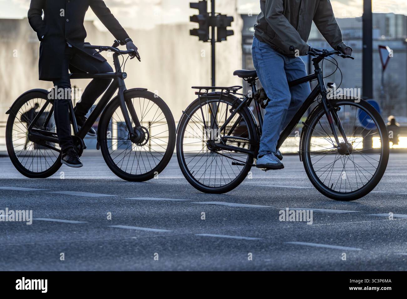two male cyclists one behind the other on the road Stock Photo - Alamy