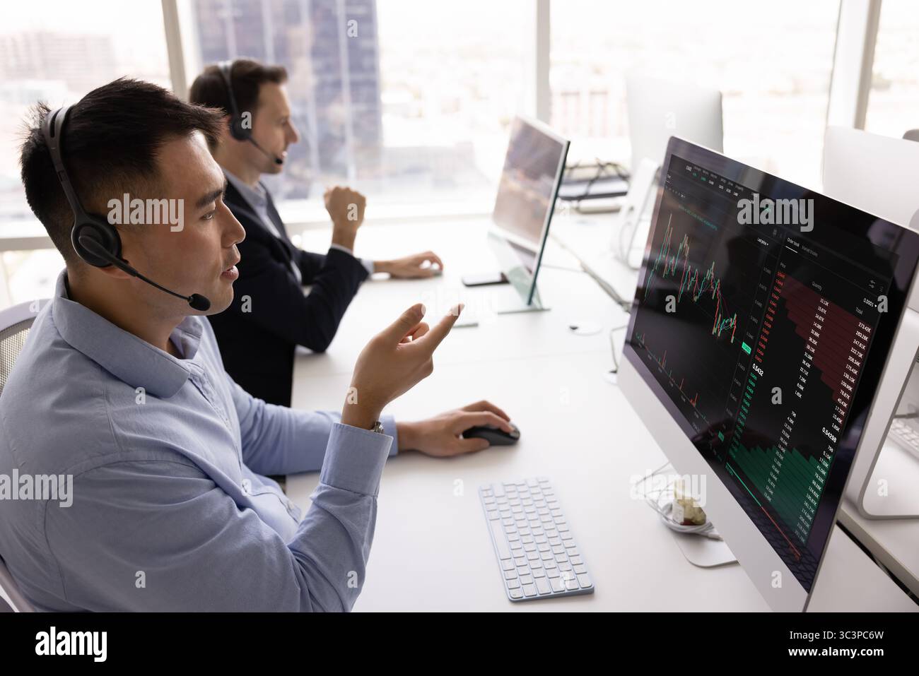 Man looking at monitor displaying financial trading charts Stock Photo ...