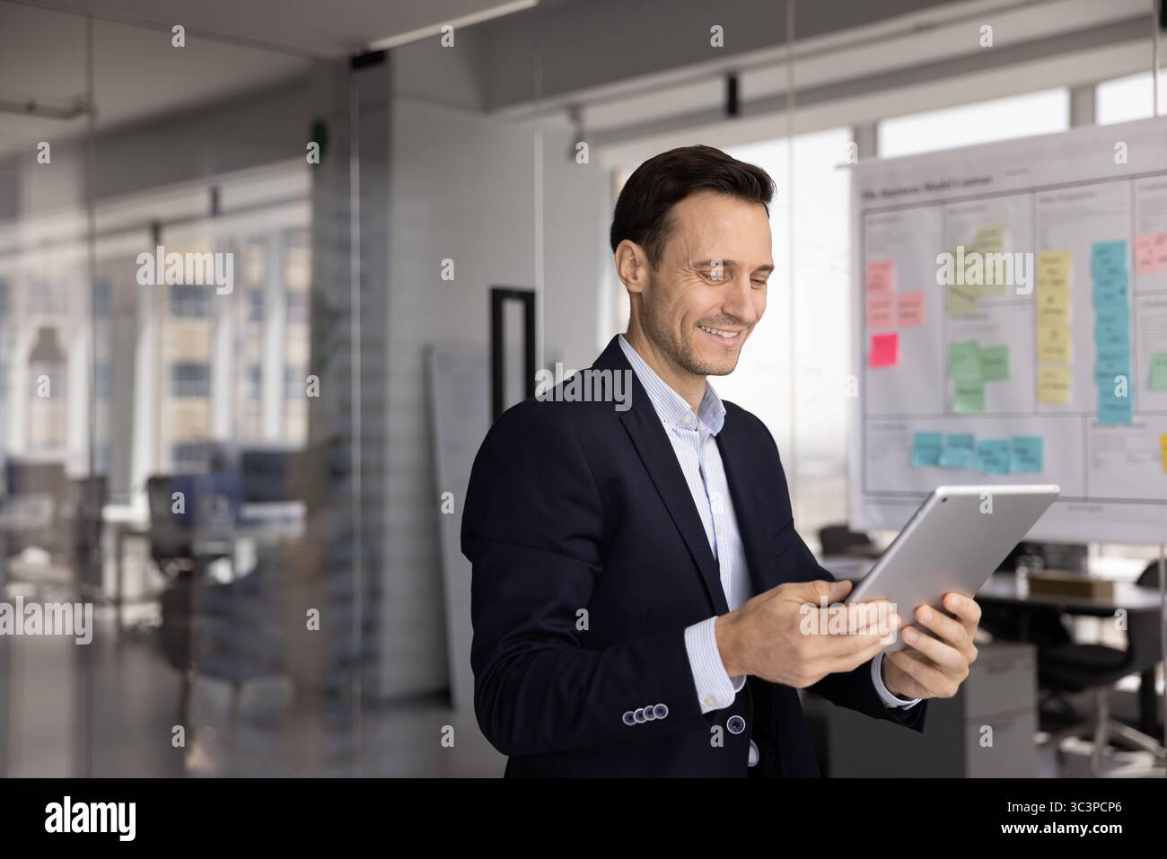 Smiling businessman accessing information hi-res stock photography and ...