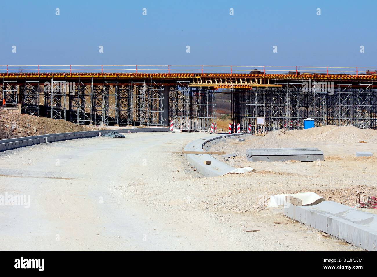 A major bridge is being constructed using extensive scaffolding, with ...