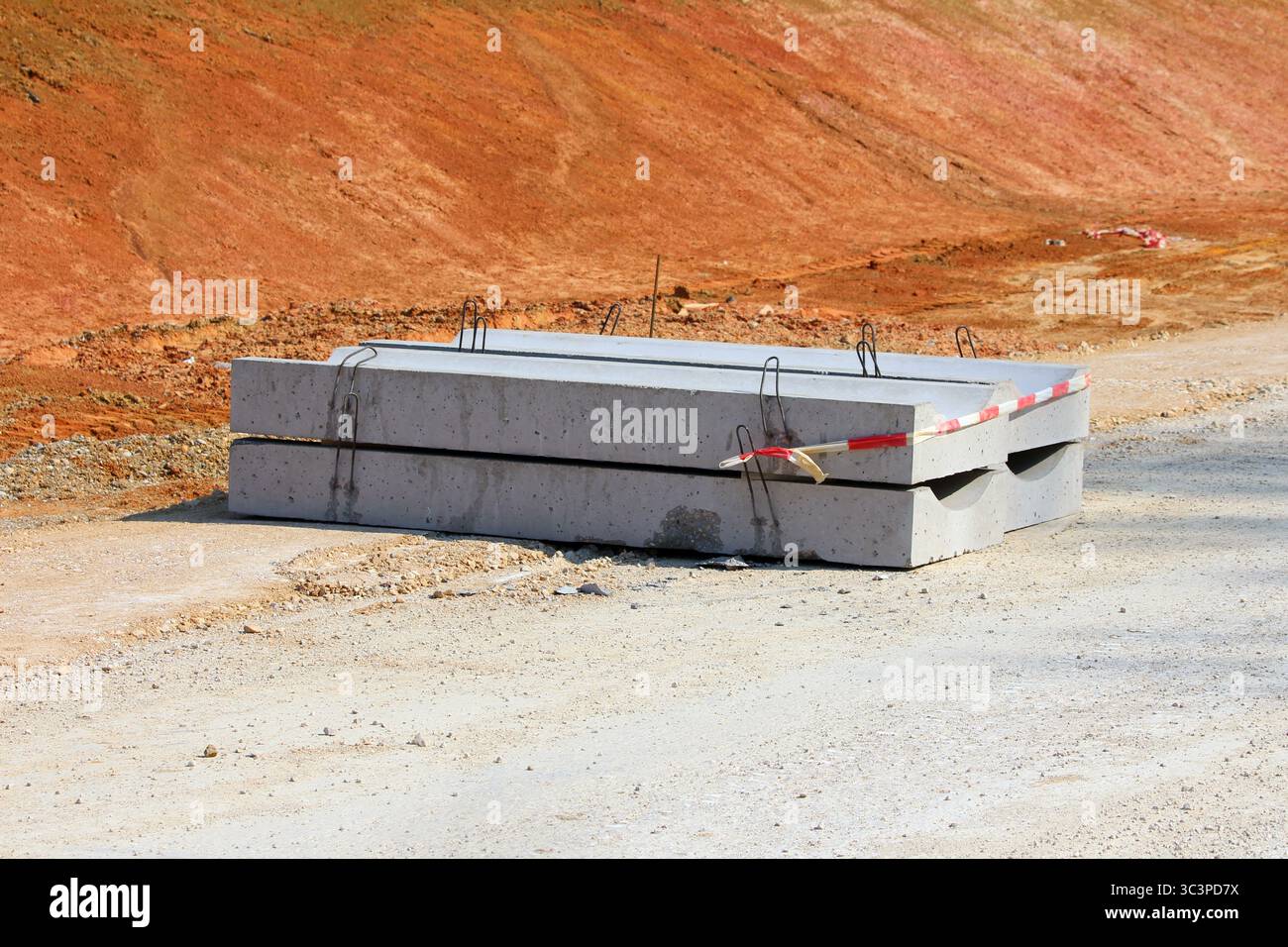 Two large pre-cast concrete culvert sections with lifting hooks are ...