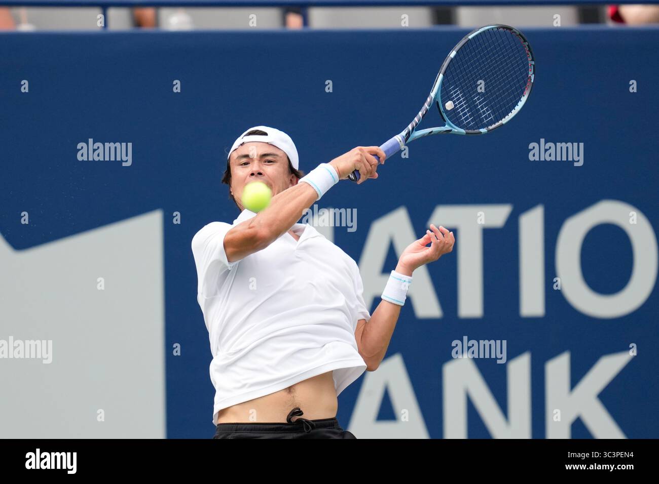 Taro Daniel of Japan plays a forehand against Dan Martin of Canada ...