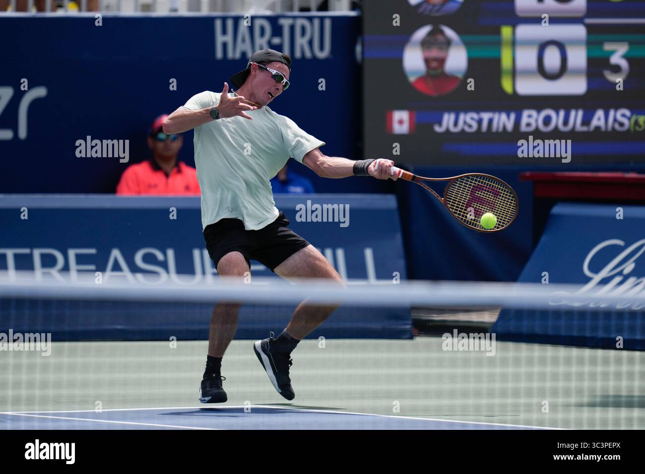 Justin Boulais of Canada plays a forehand against James Duckworth of ...