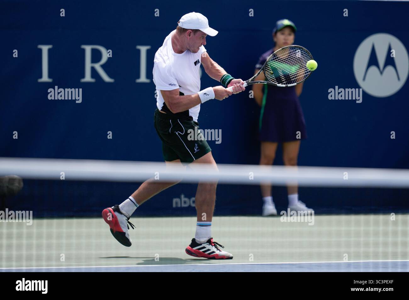 James Duckworth of Australia plays a backhand against Justin Boulais of ...