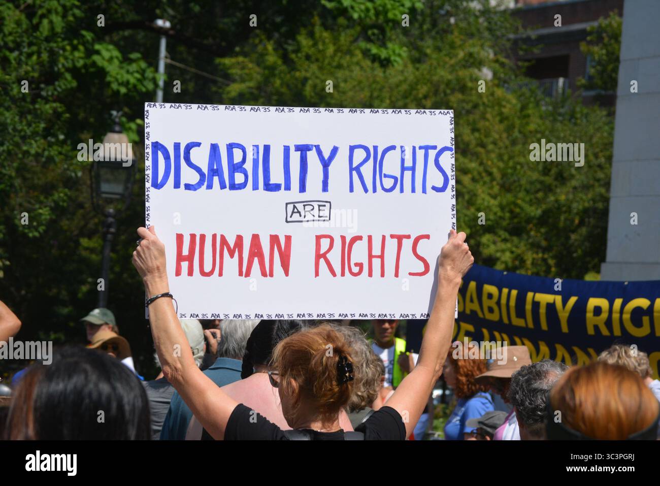 Sign at a rally celebrating the anniversary of the Americans with ...