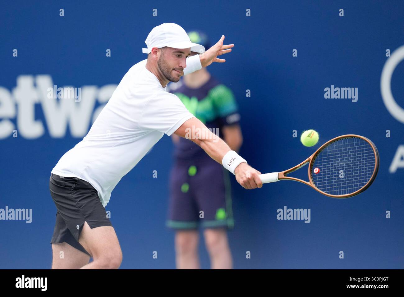 Dan Martin of Canada plays a backhand against Taro Daniel of Japan ...