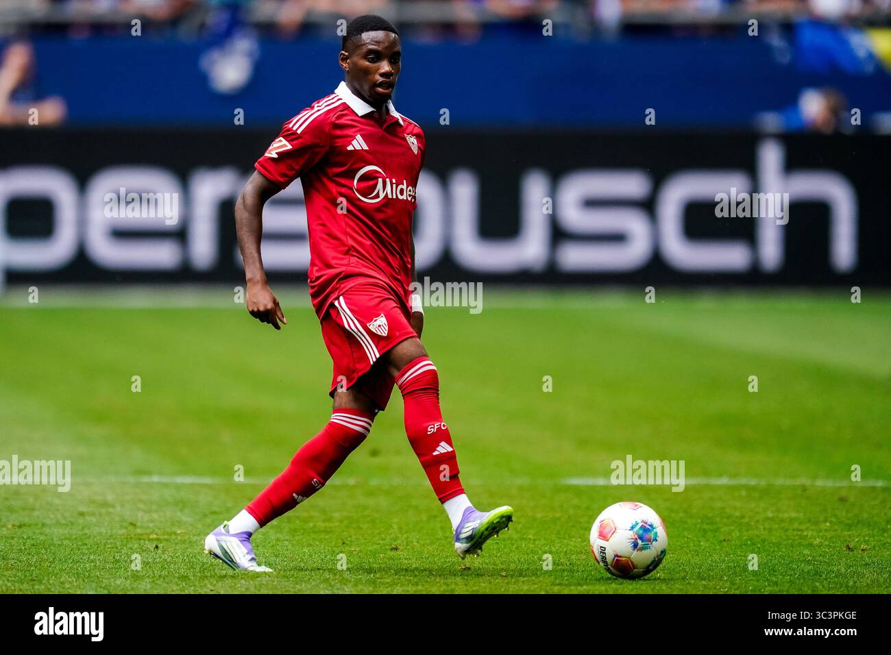 GELSENKIRCHEN, GERMANY - JULY 26: Stanis Idumbo of Sevilla FC passes ...