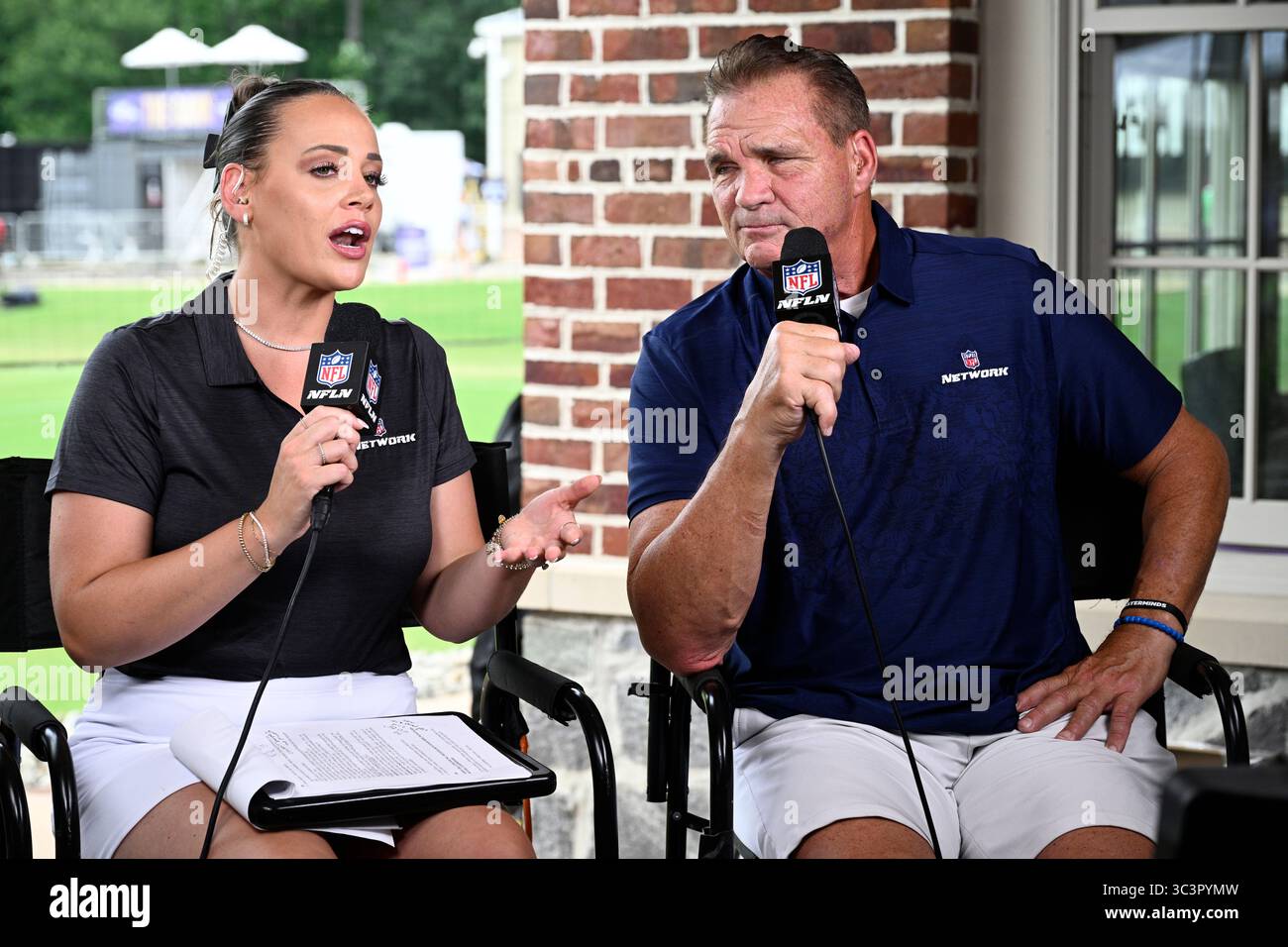 NFL Network reporters Bridget Condon, left, and Brian Baldinger, right, during practice at the ...
