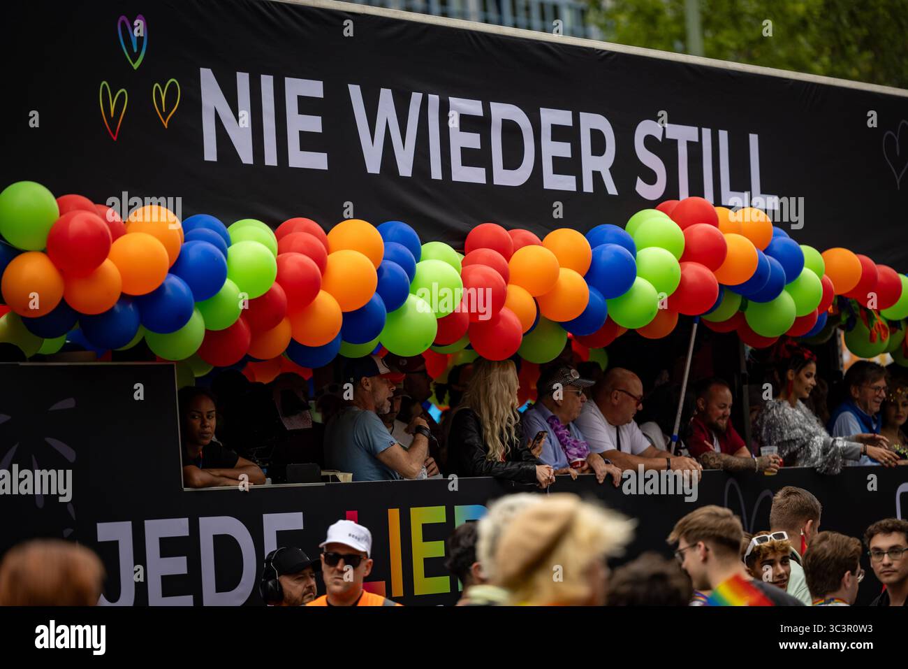 Participants in the Berlin Pride Parade ride on party trucks playing ...