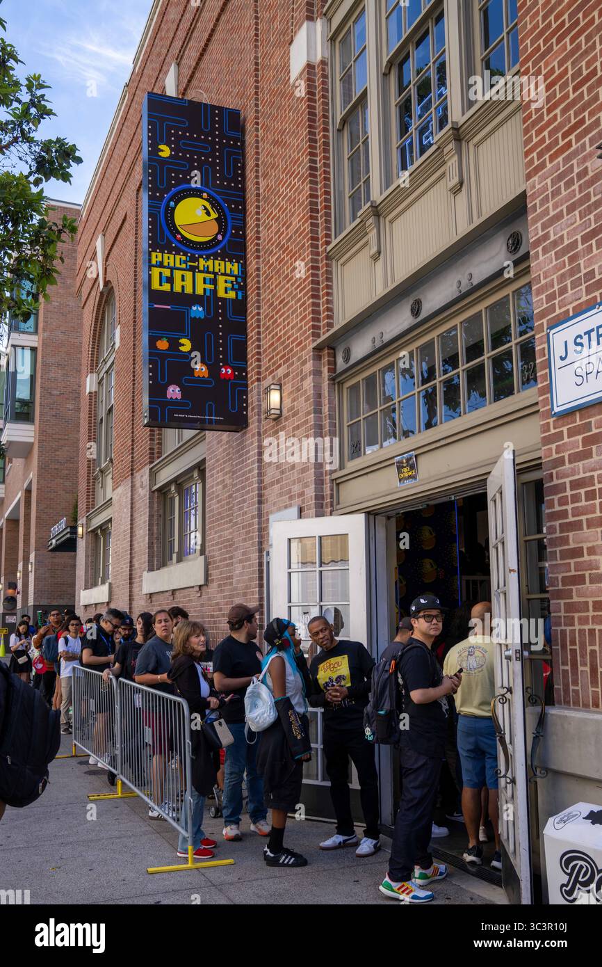 Fans line up outside the Pac-Man Café, a temporary rebranding of a ...
