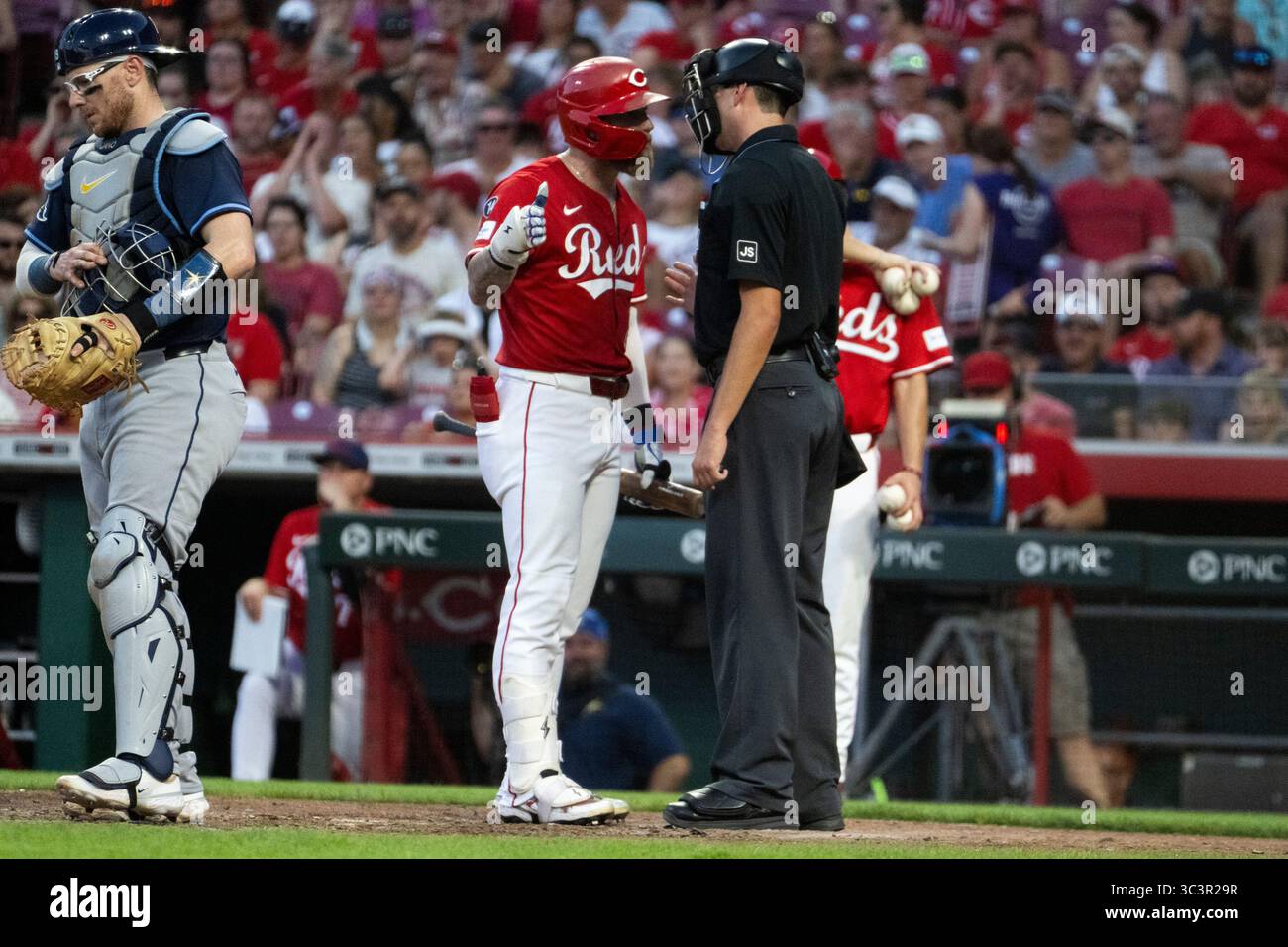 Cincinnati Reds' Jake Fraley, center left, argues with the umpire ...