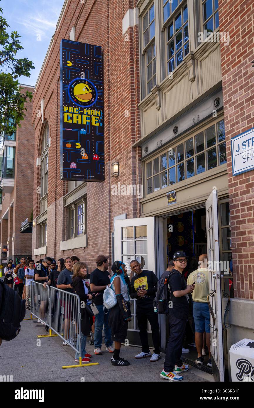 Fans line up outside the Pac-Man Café, a temporary rebranding of a ...