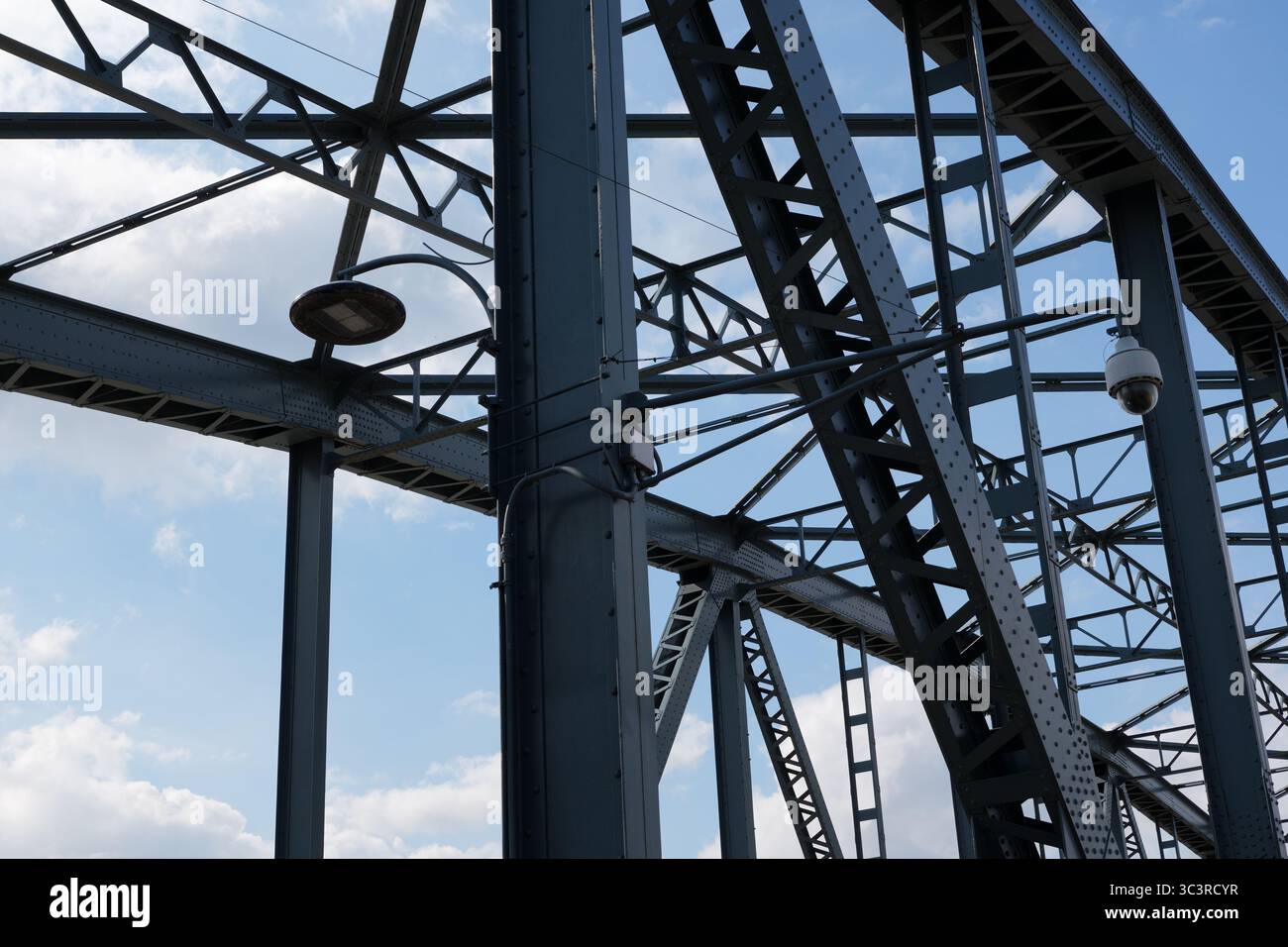Truss bridge close-up with a street lamp and a cctv camera Stock Photo ...