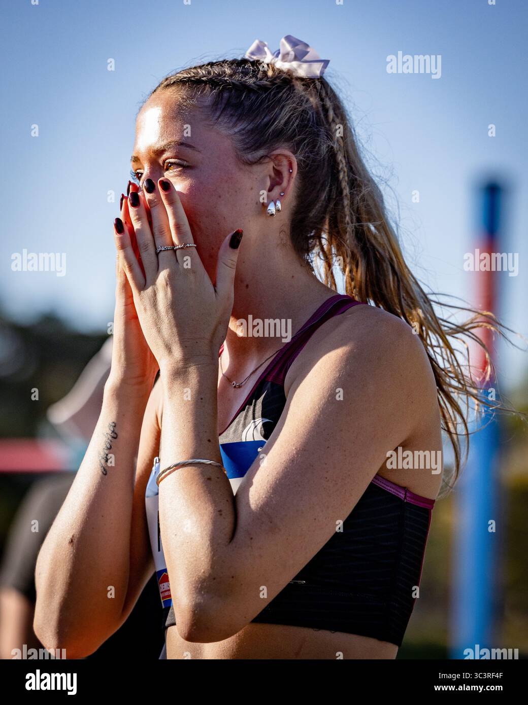 Zoe Peacock from Queensland wipes the tears from her face after jumping a personal best in the ...