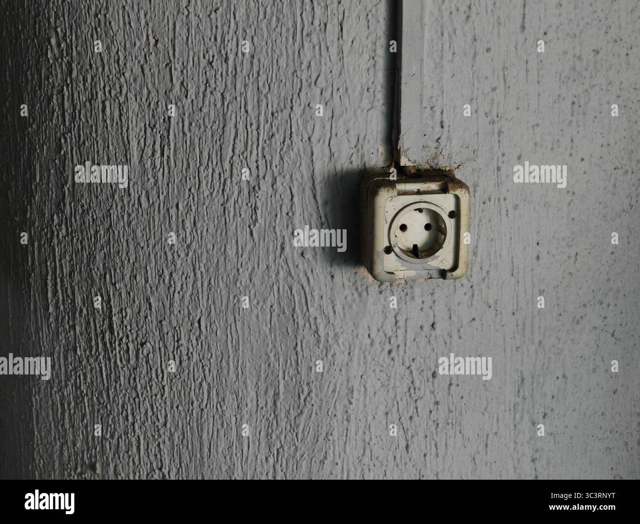 Minimal Power: Socket on Wall with Negative Space Stock Photo - Alamy