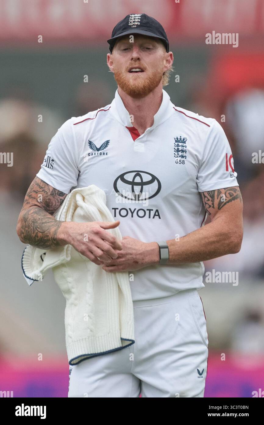 England captain Ben Stokes puts his hat on after finishing his over ...