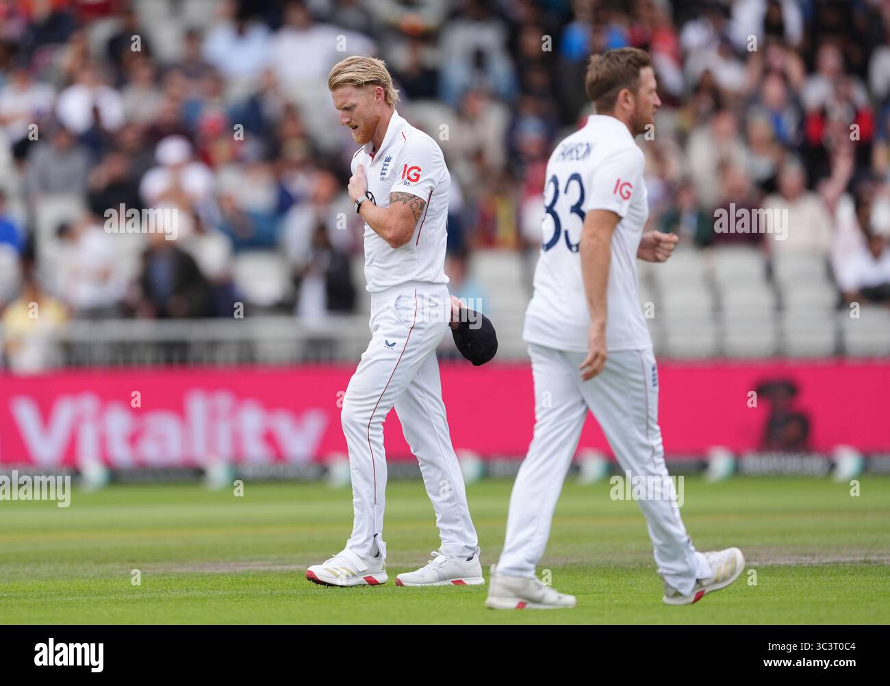 England's captain Ben Stokes rubs his shoulder after bowling an over ...