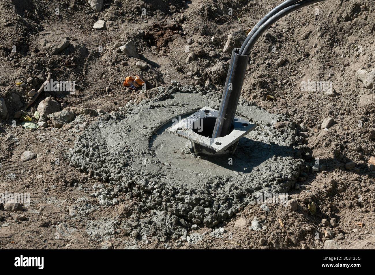 The process of installing a concrete base with a metal pipe at a ...