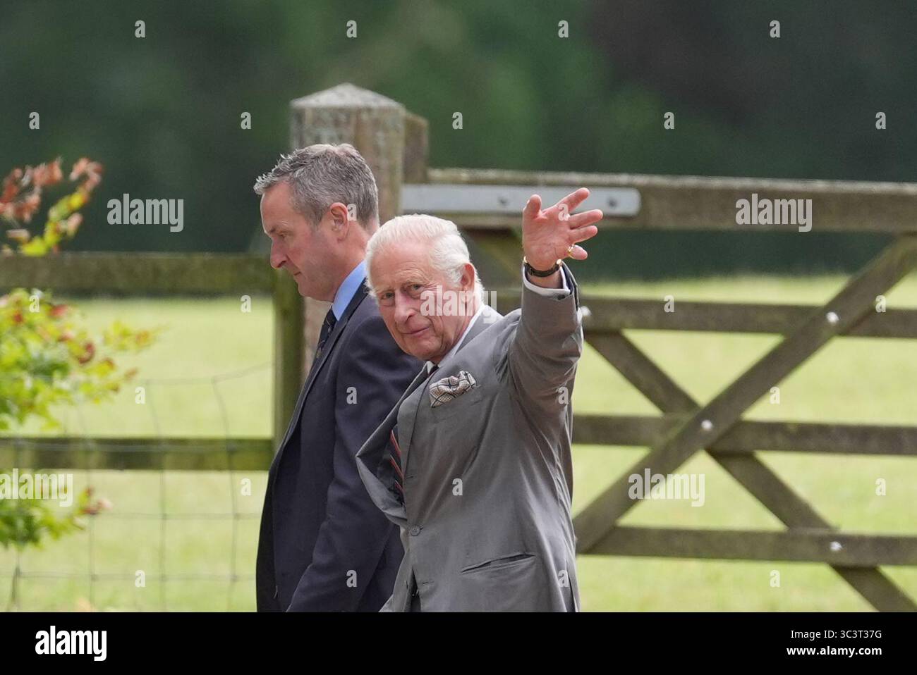 King Charles III waves as he leaves following a Sunday church service ...