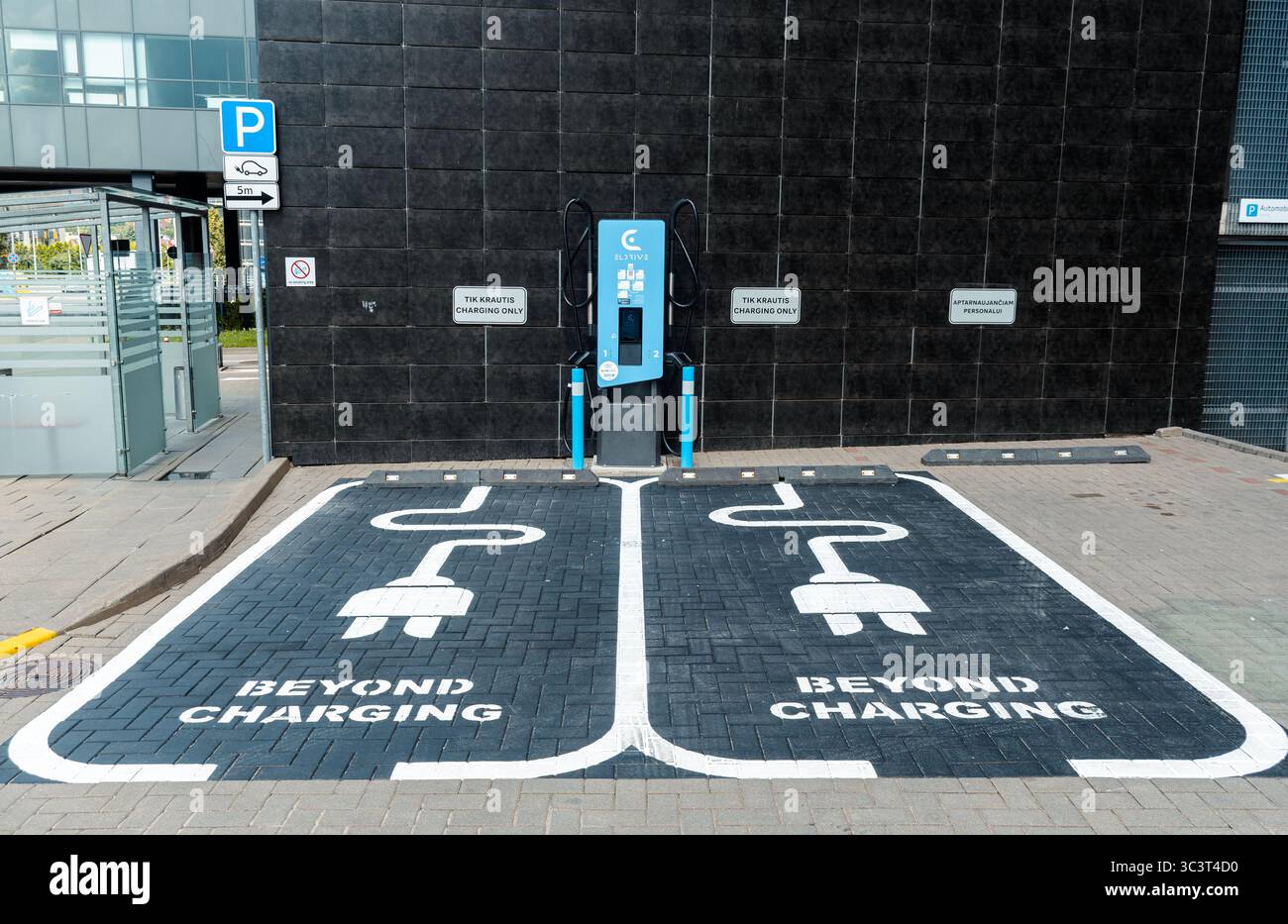 Charging stations and parking spots in a designated parking area with ...