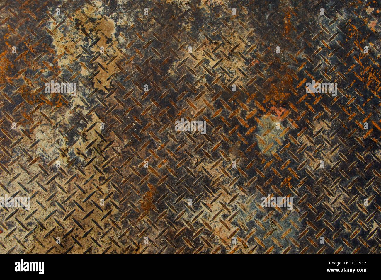 A detailed view of grungy rusty diamond plate metal surface. Highlights ...