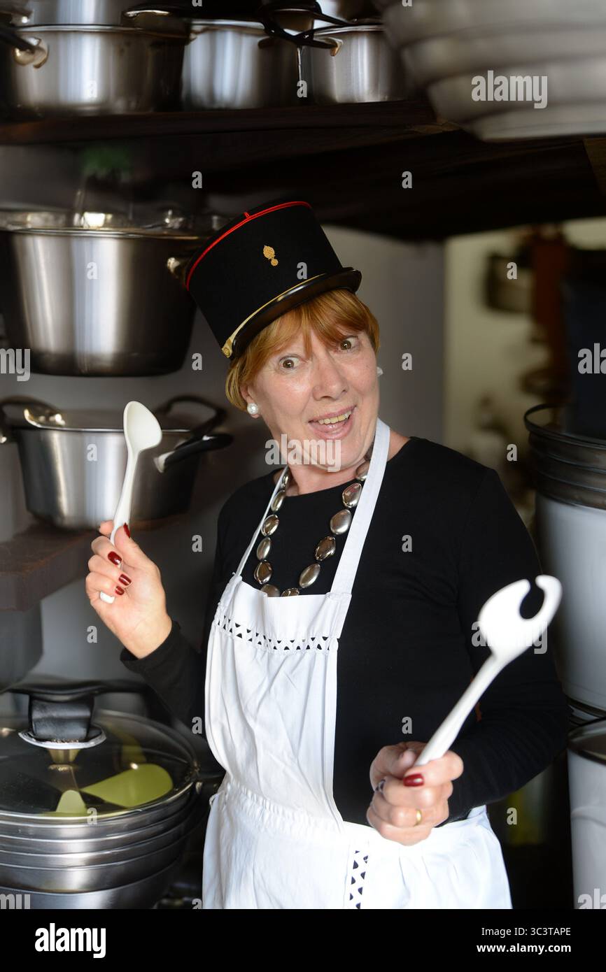 French style cheeky woman cook chef wearing apron Stock Photo - Alamy