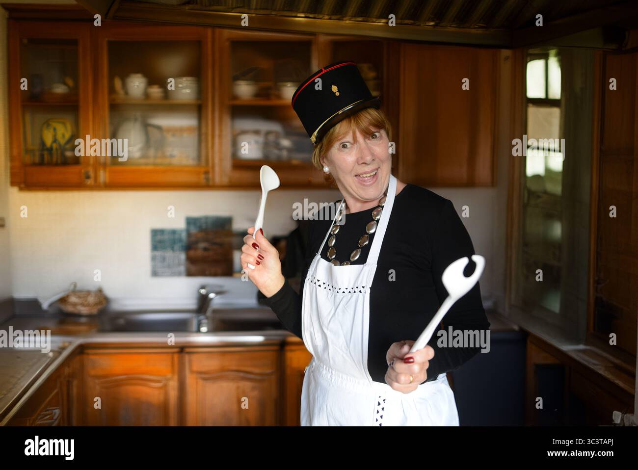 French style cheeky woman cook chef wearing apron Stock Photo - Alamy