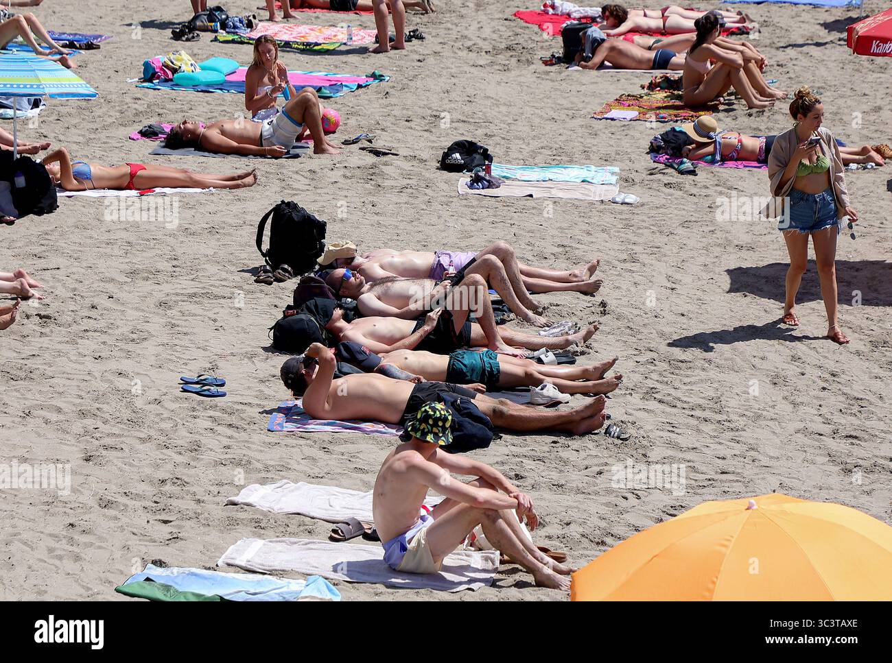 People enjoy swimming and sunbathing on the beach bacvice in split, croatia on july 27, 2025. hi ...