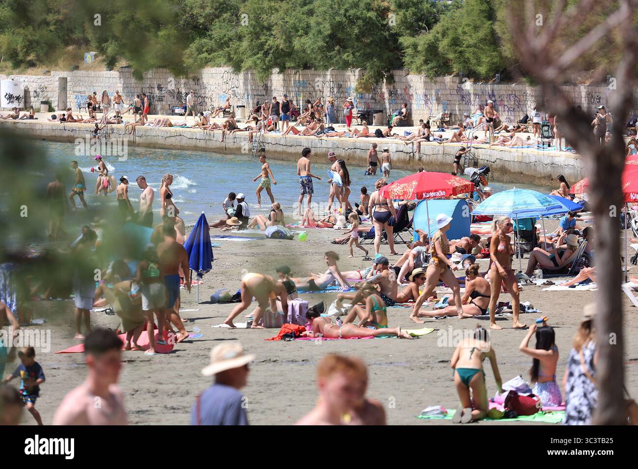 People enjoy swimming and sunbathing on the beach bacvice in split, croatia on july 27, 2025. hi ...