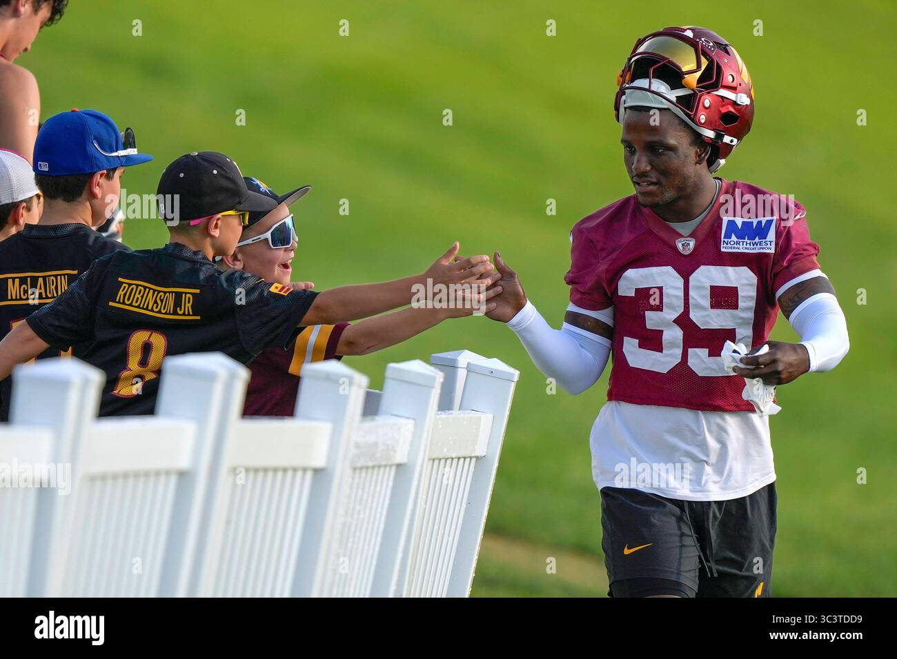Washington Commanders safety Jeremy Reaves (39) high-fives fans as he ...