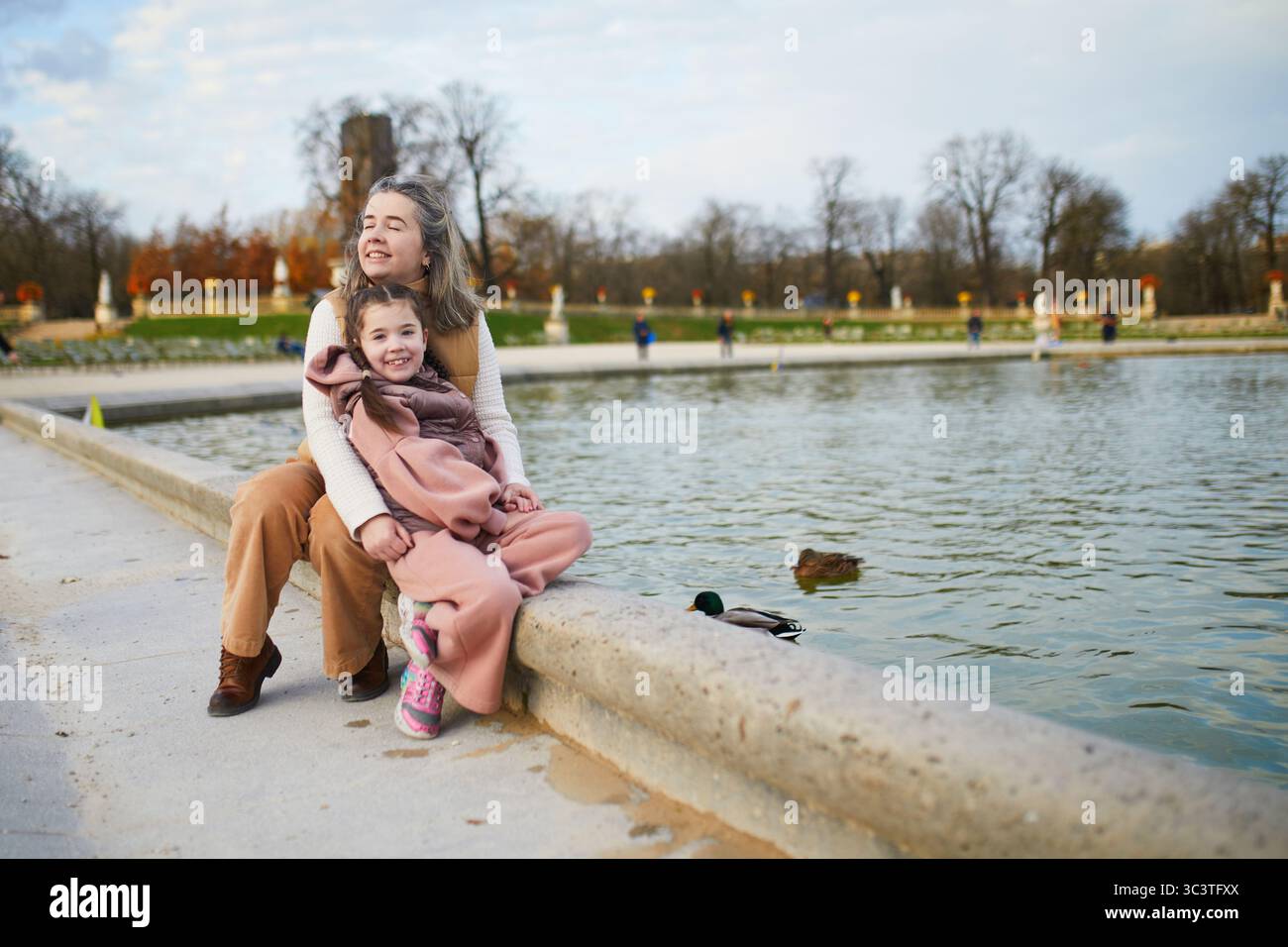 Mother and daughter enjoying family time together in Luxembourg garden ...