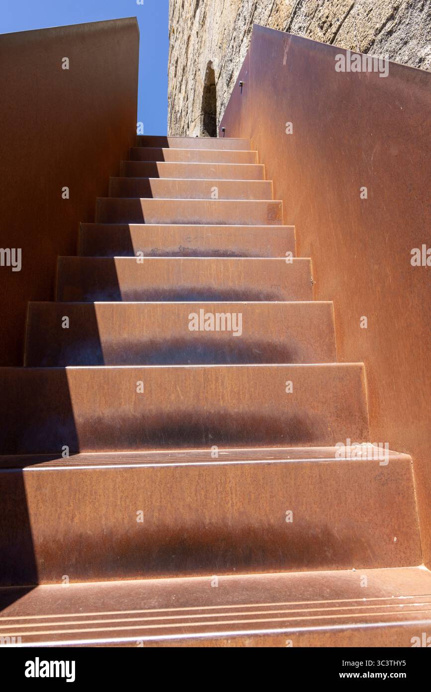 The stairs are made of metal and are brown in color. They are very ...