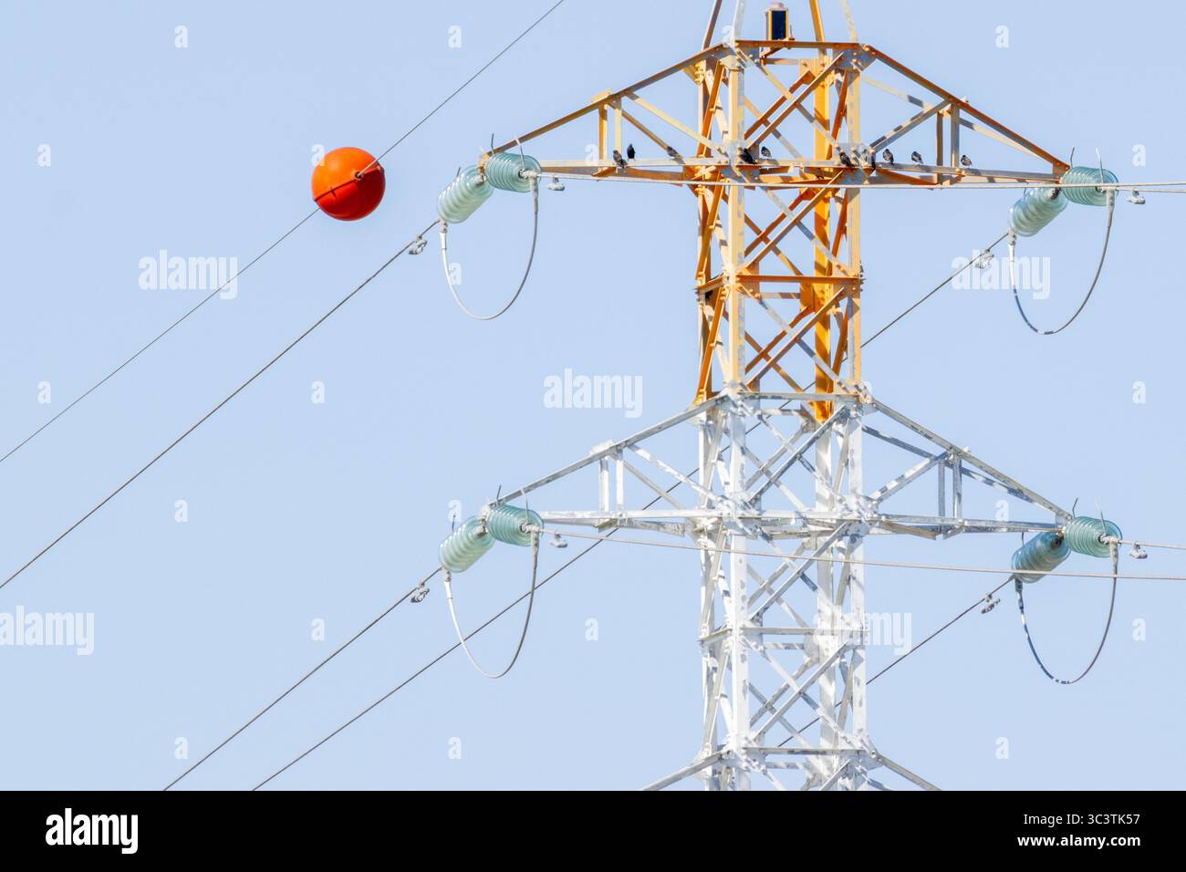 Orange sphere marking power lines for aircraft visibility, enhancing ...
