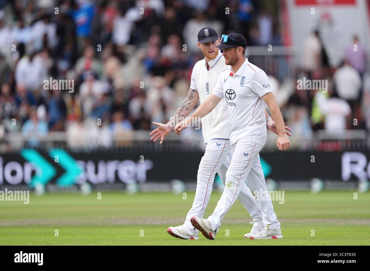 England's captain Ben Stokes speaking to Liam Dawson as they walk off ...