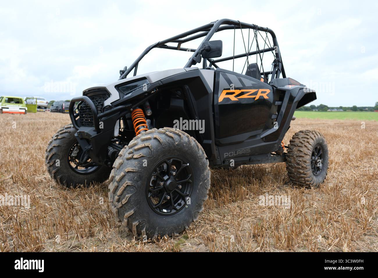 Polaris RZR two seat al terrain vehicle on a farm stubble field in UK ...