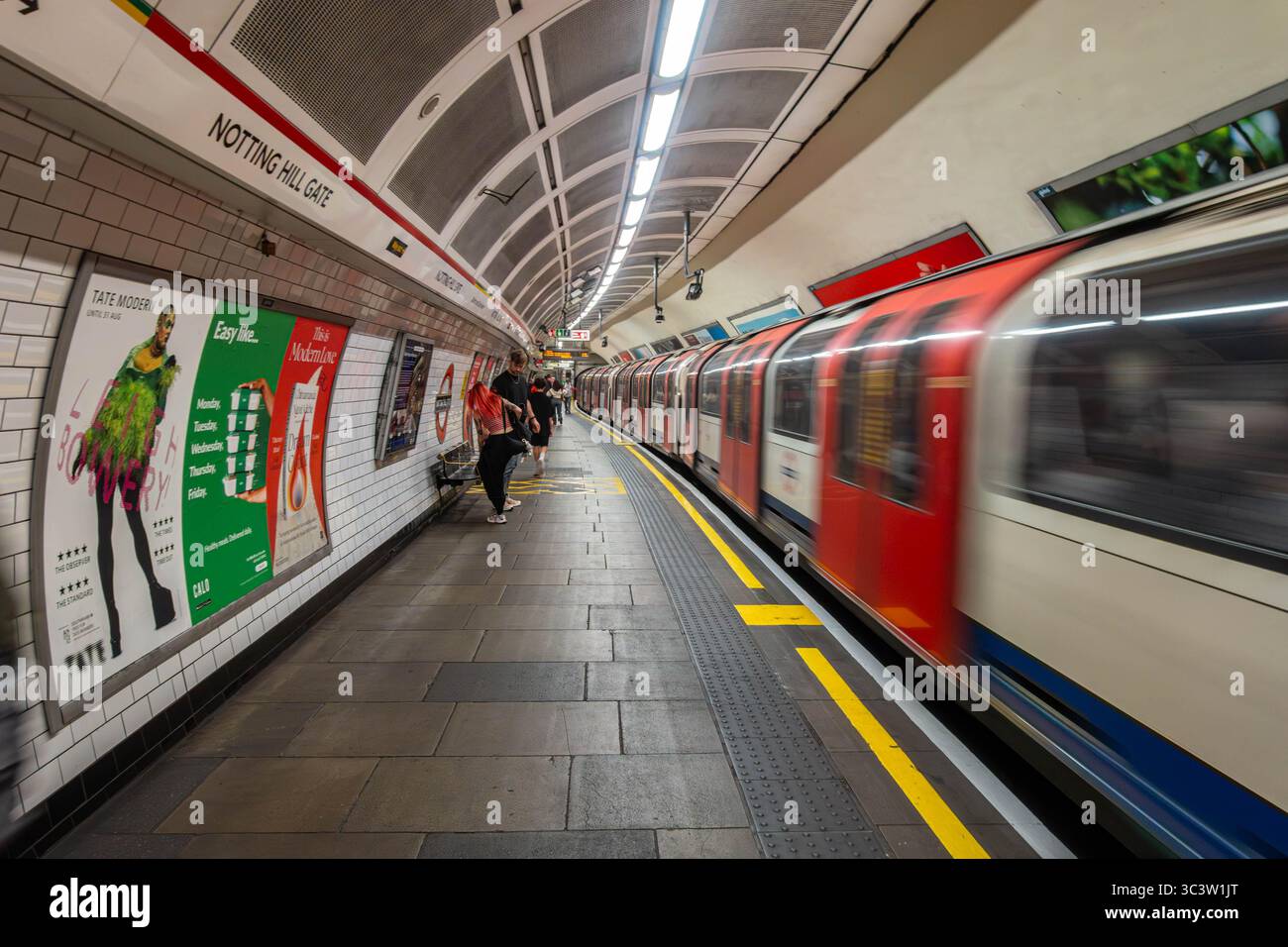 A train departs from Notting Hill Gate London Underground Station on ...