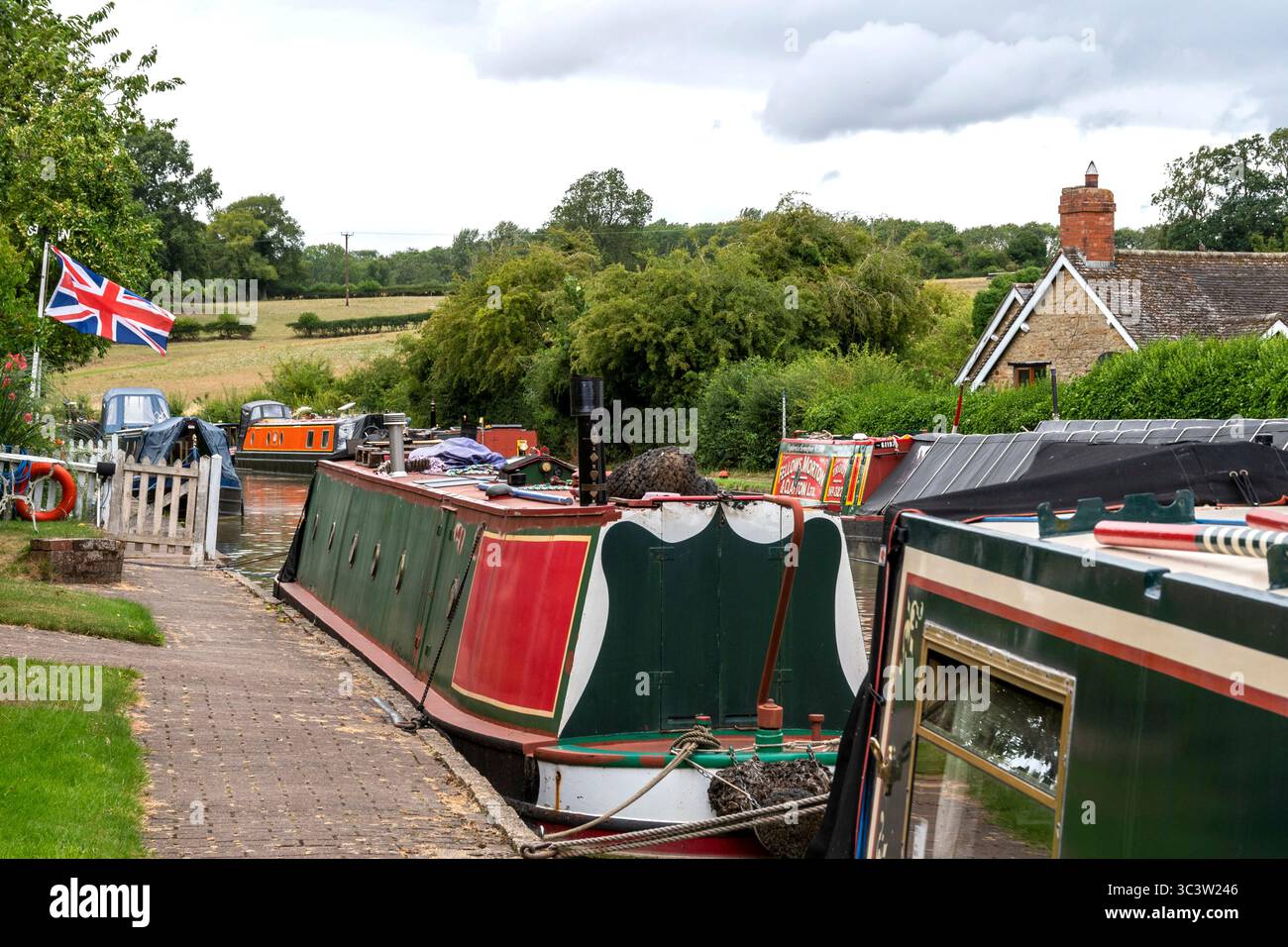 Canal side view showing moored barges and scenery Stock Photo - Alamy