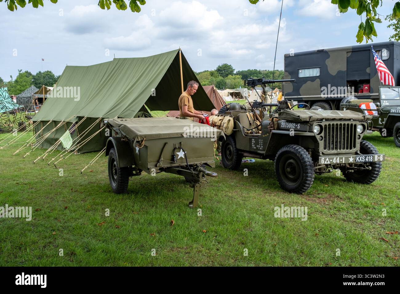 Soldier, US jeep and military tent at a second World War re-enactment ...