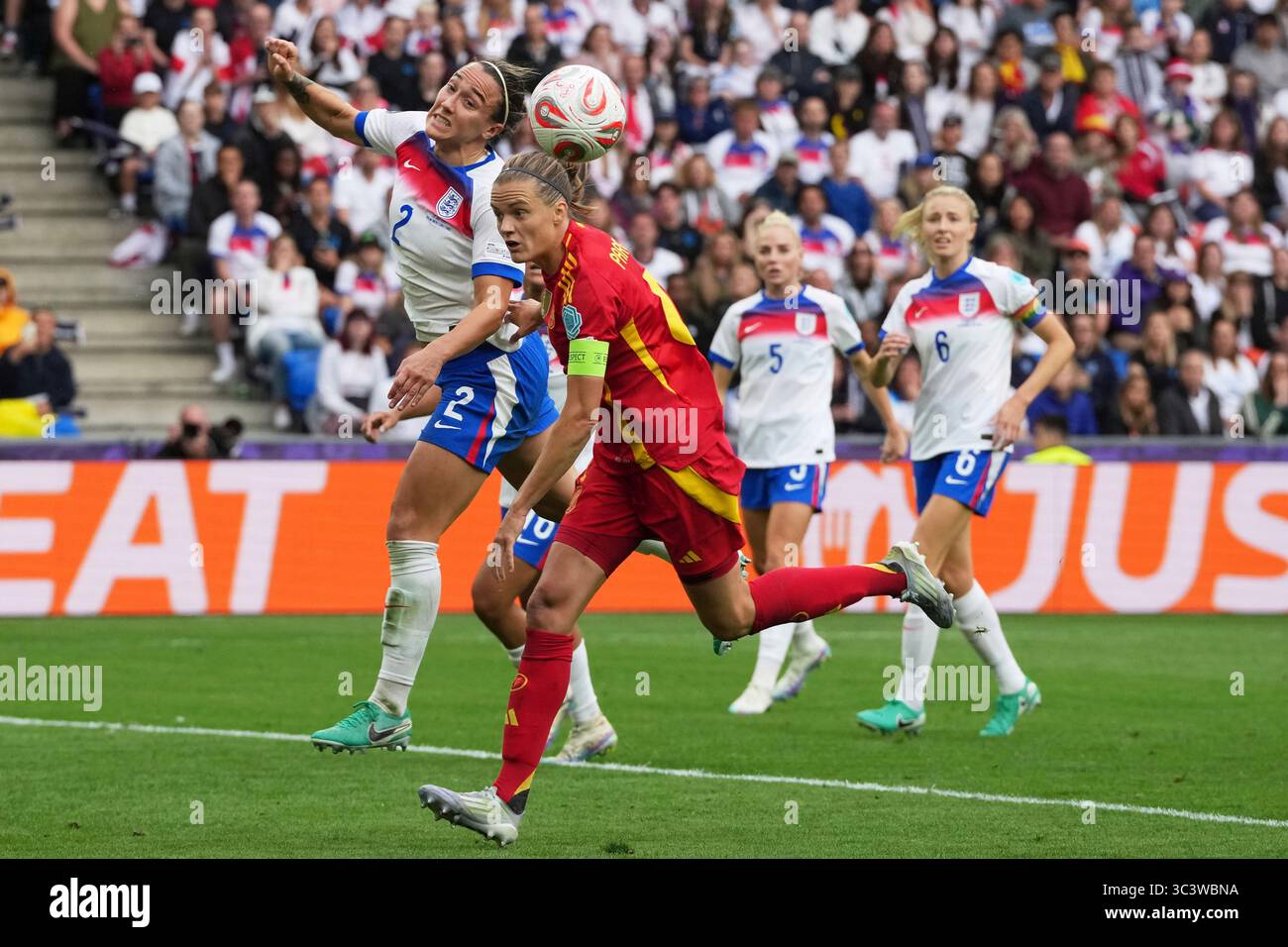 England's Lucy Bronze, left, heads the ball ahead of Spain's Irene ...