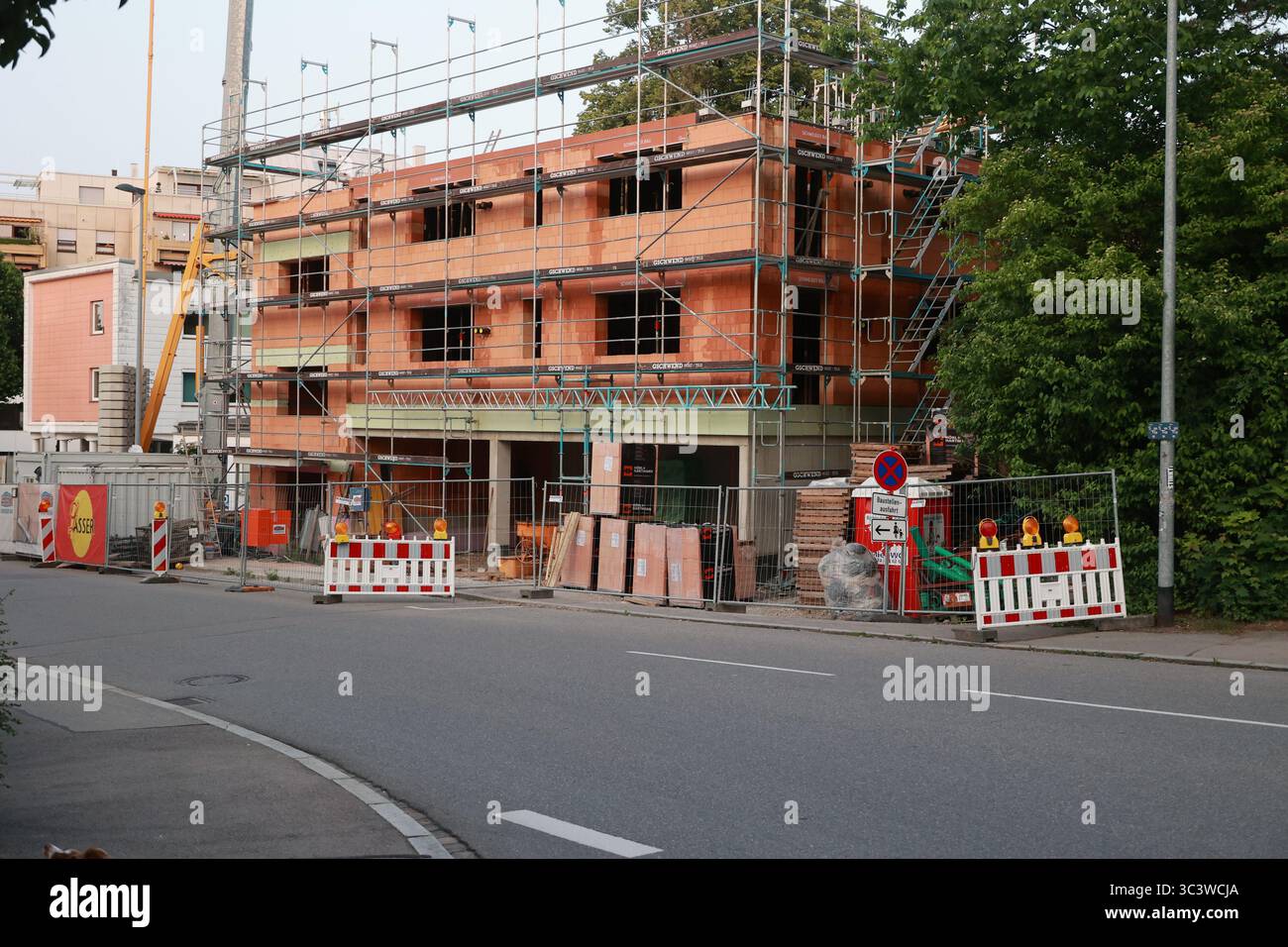 Construction site is visible on the side of a street Stock Photo - Alamy