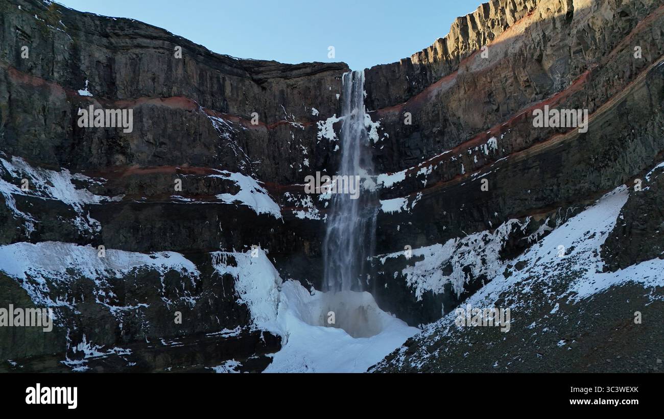 One of the tallest waterfalls in Iceland, dropping 128 meters! The red ...