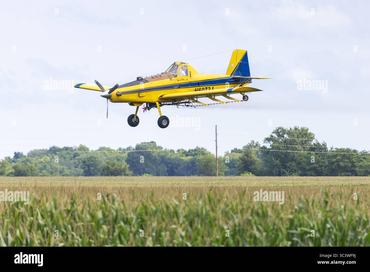 A crop-dusting airplane near Wapello, Iowa applies liquid fungicide to ...