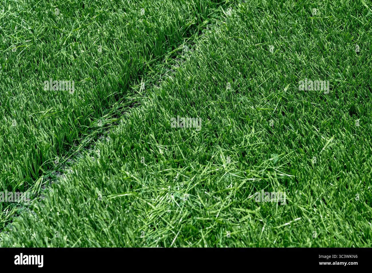 Synthetic turf field under construction with lines and graphics being ...