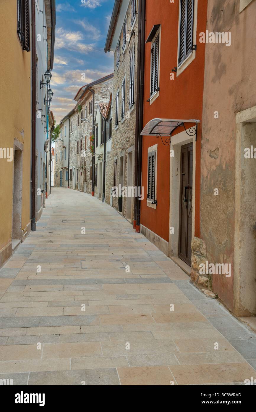 Charming narrow street with rustic stone houses in a peaceful town ...