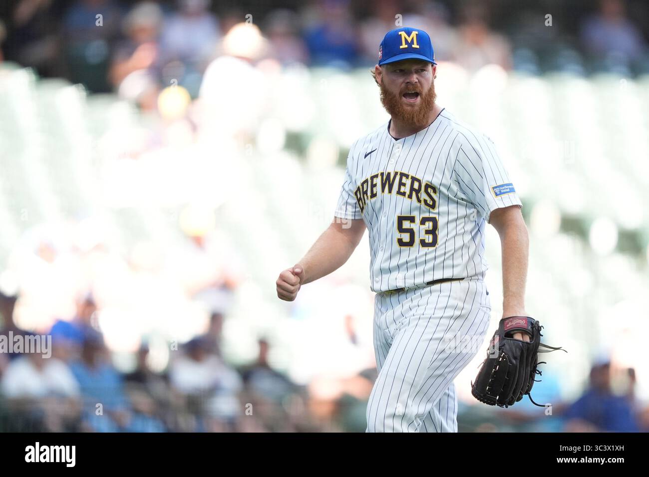 Milwaukee Brewers' Brandon Woodruff reacts as he walks to the dugout ...