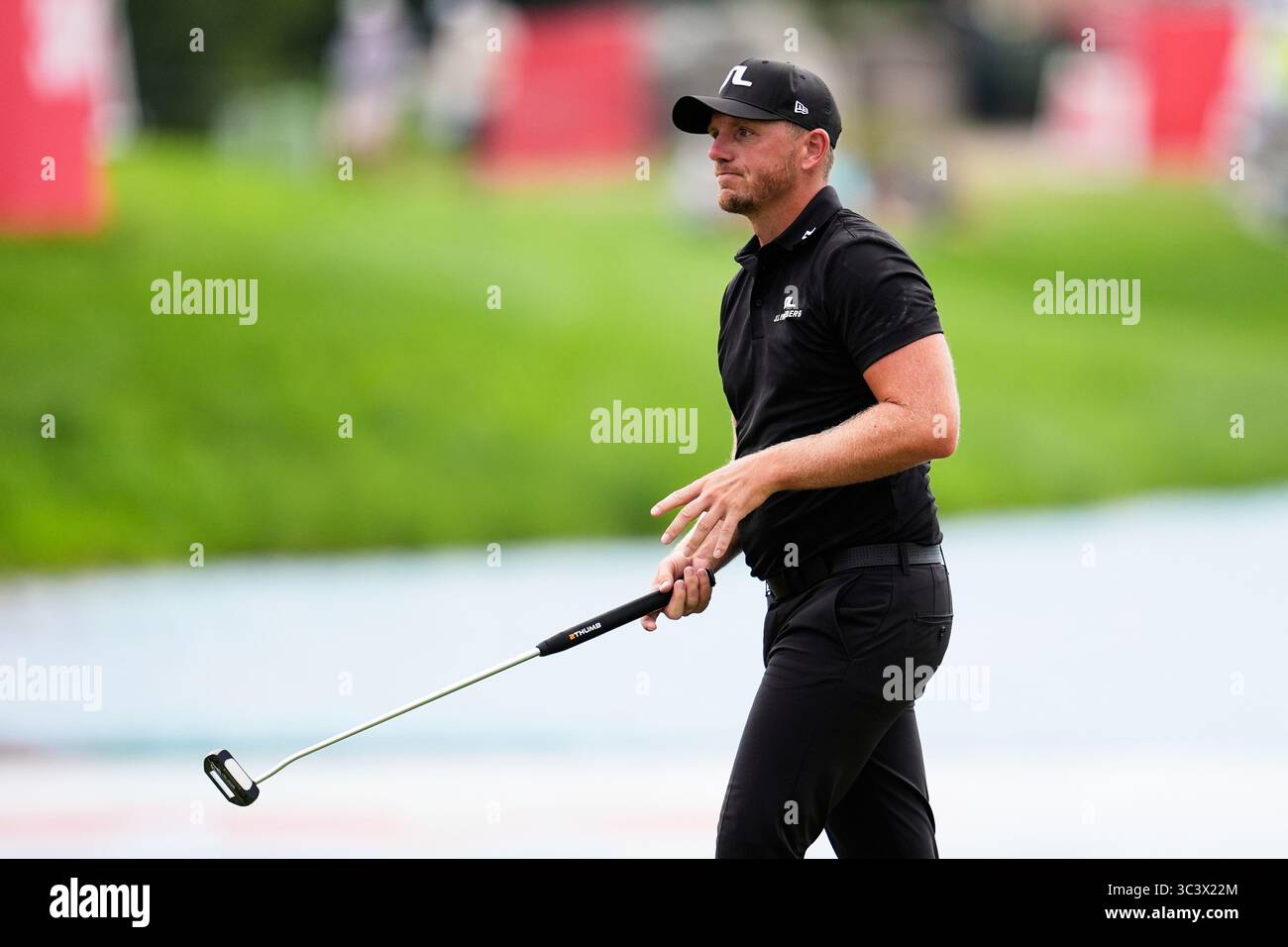 Matt Wallace reacts after his putt on the 18th green during the final ...