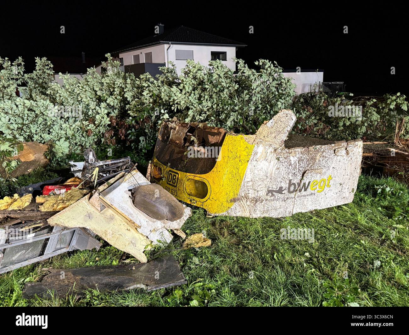 A front section of the derailed regional passenger train lies in a ...
