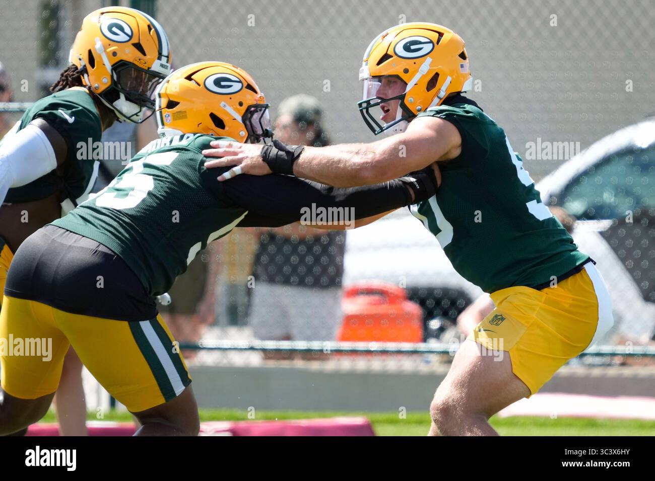 Green Bay Packers' Devonte Wyatt, front left, and Lukas Van Ness, right ...