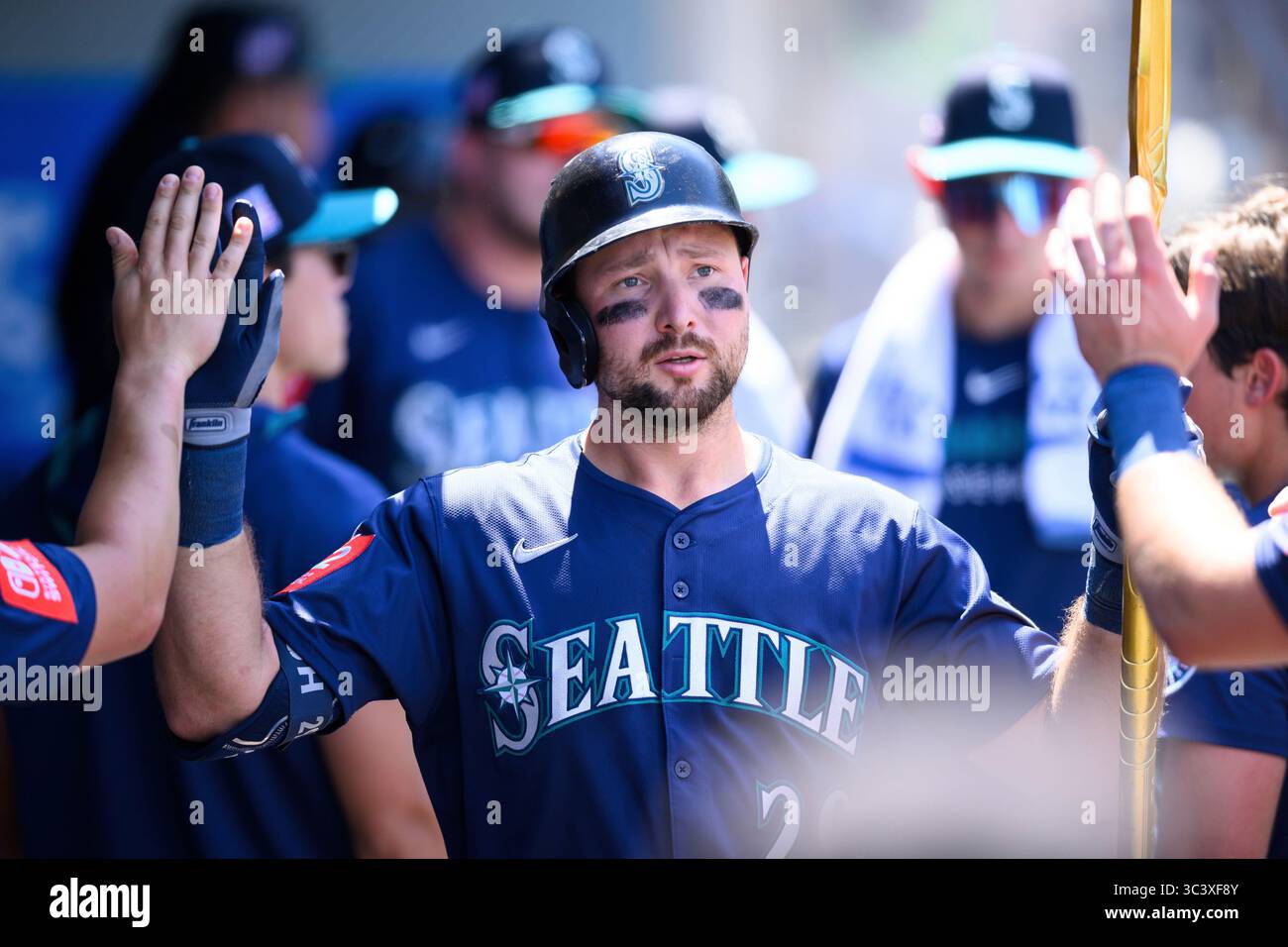 Seattle Mariners' Cal Raleigh is greeted by teammates after hitting a ...