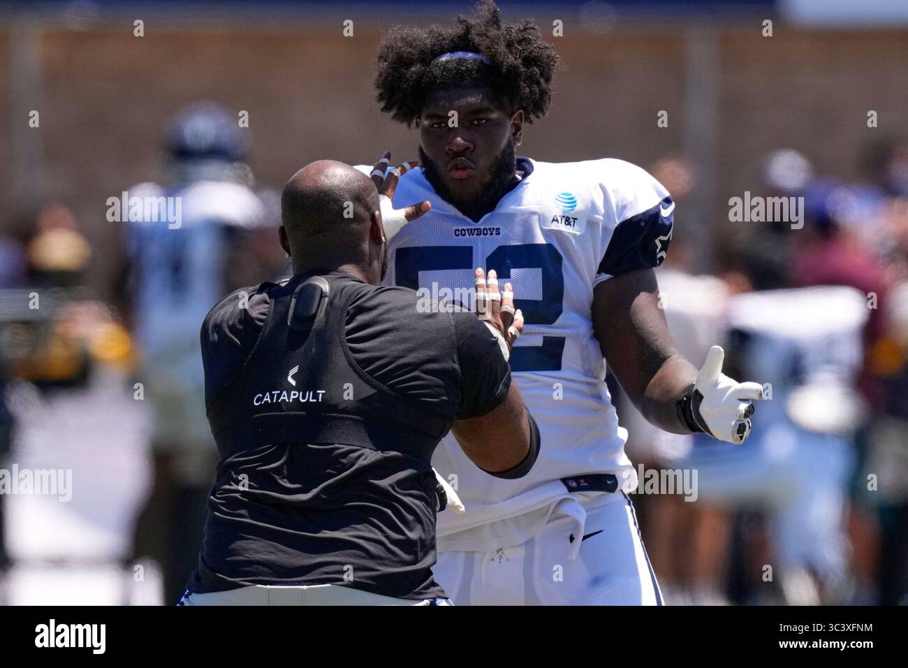 Dallas Cowboys guard Robert Jones, left, works with guard Tyler Booker ...